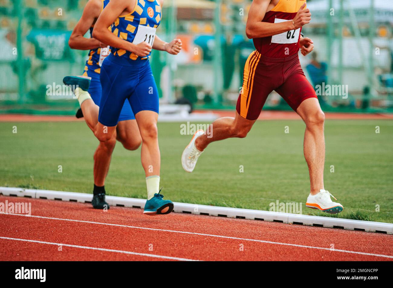 Determined male athletes legs pushing through the long distance race ...
