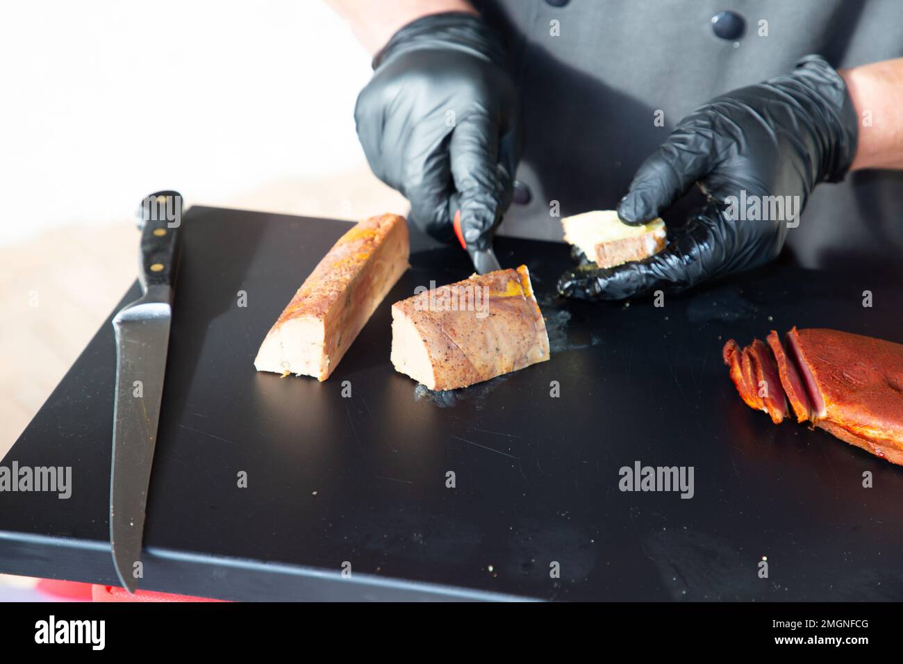 restaurant waiter cutting deli meats in events party Stock Photo - Alamy