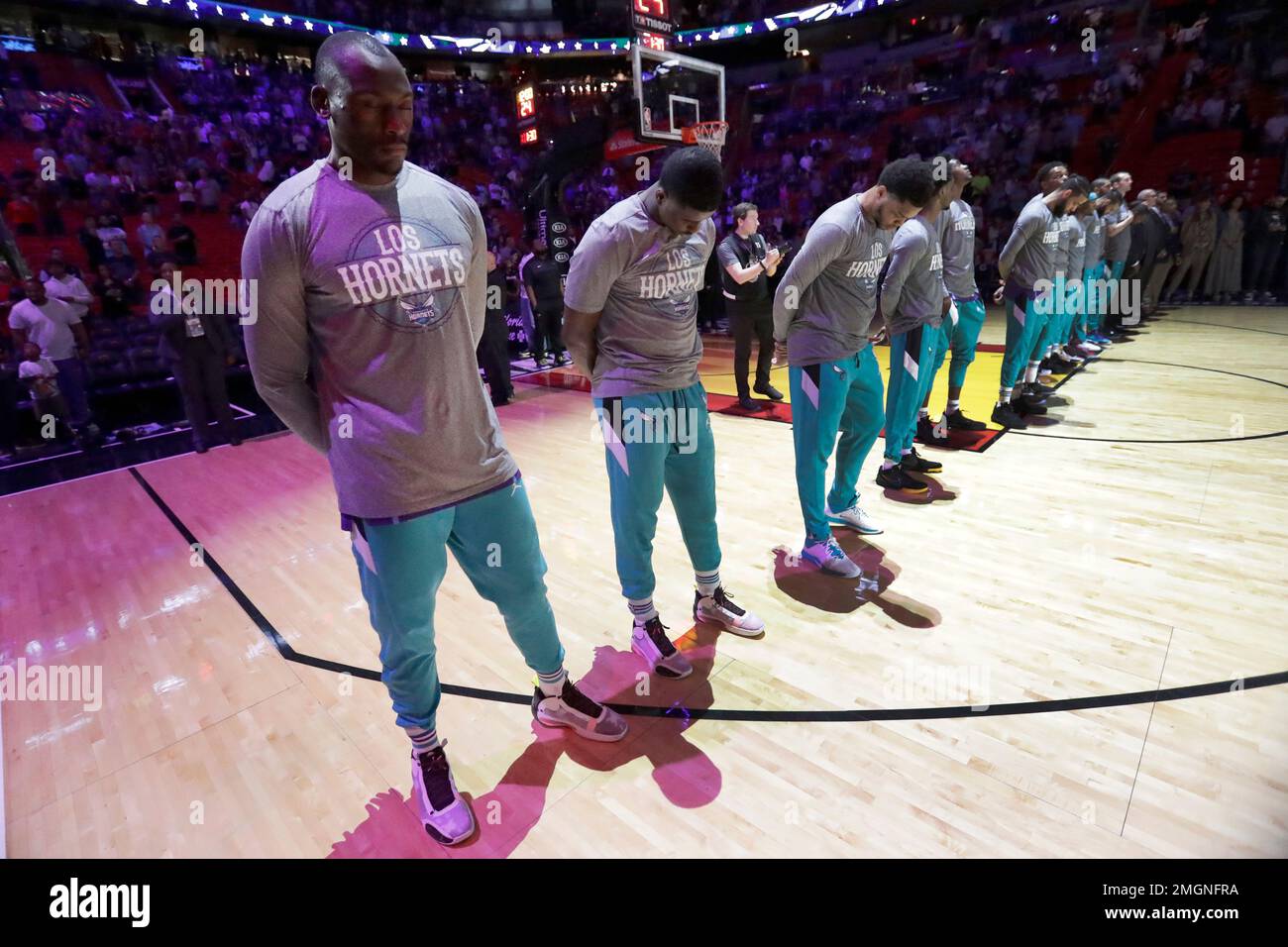 Charlotte Hornets players stand during the singing of the National ...