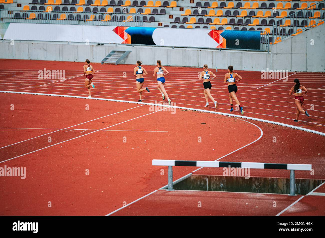 Determined female athletes pushing through long distance race. Great ...
