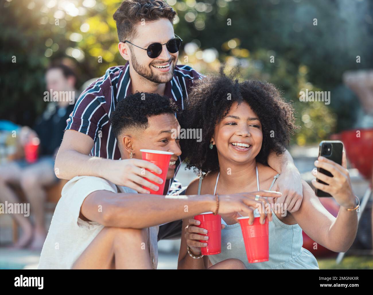 Friends, selfie and party outdoor, drinks and playful in summer, bonding together and ...