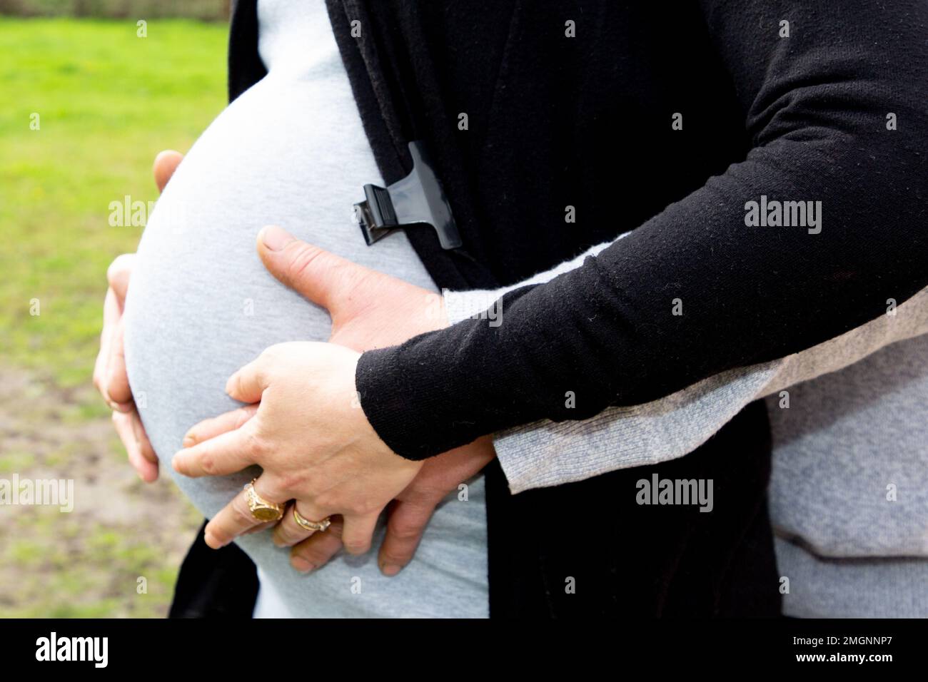 Man and woman couple in love pregnancy holding hands over pregnant ...