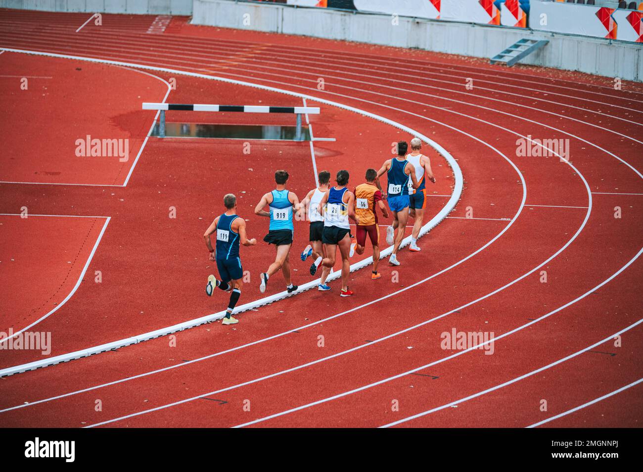 Determined male athletes in middle distance race. Ideal for promoting ...