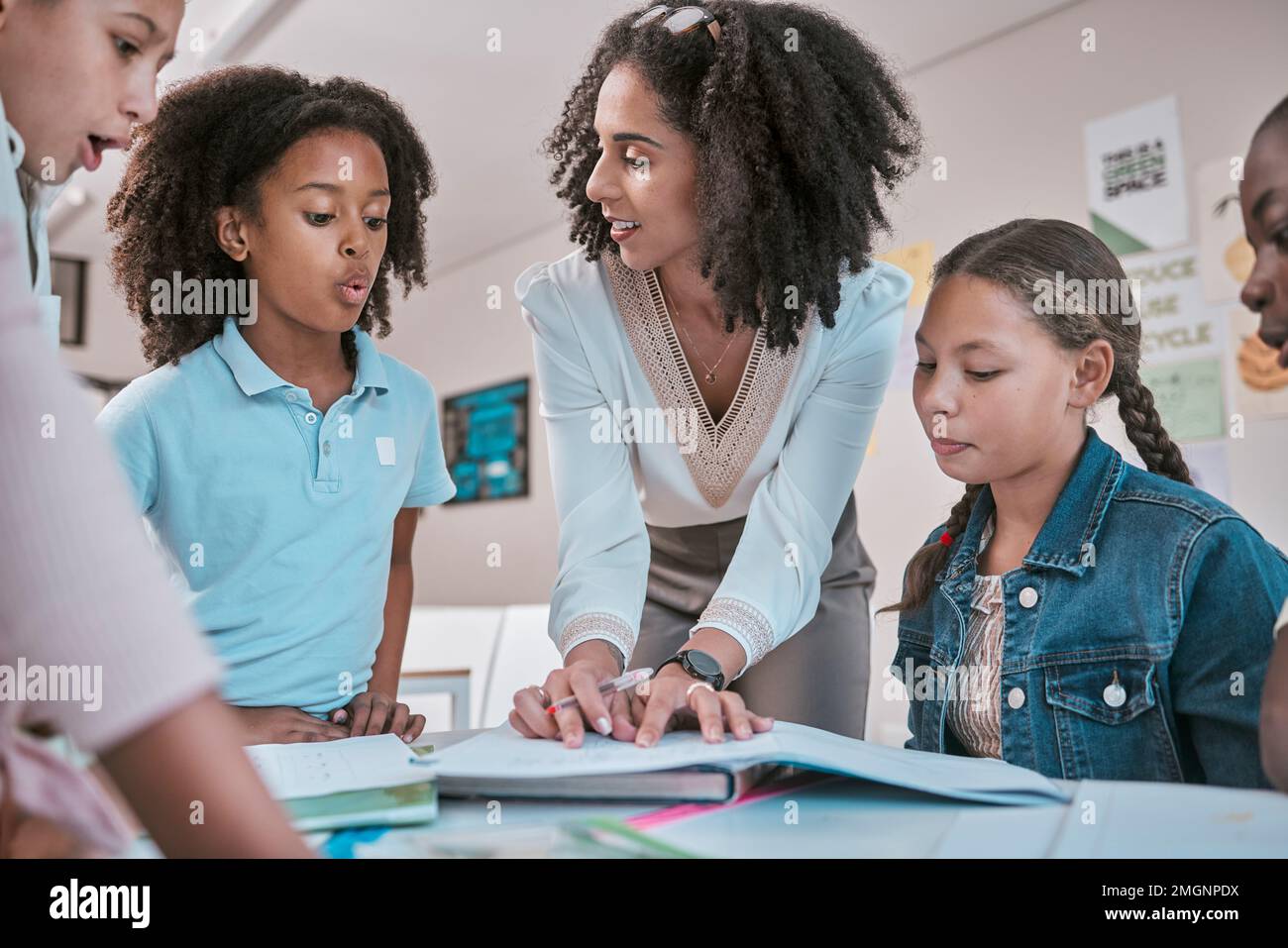 Female teacher asking student a question, children learning in ...