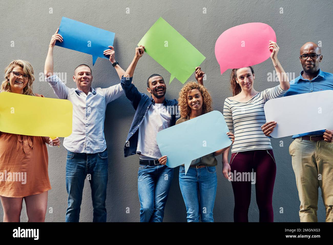 We each have something to say. Portrait of a group of people holding ...