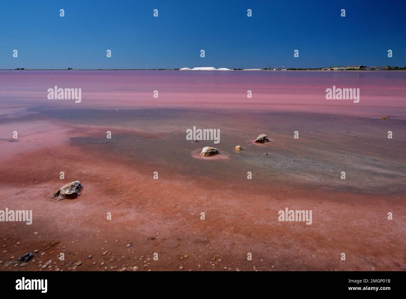 Evaporation basin in the Salins du Midi at Aigues Mortes and piles in ...