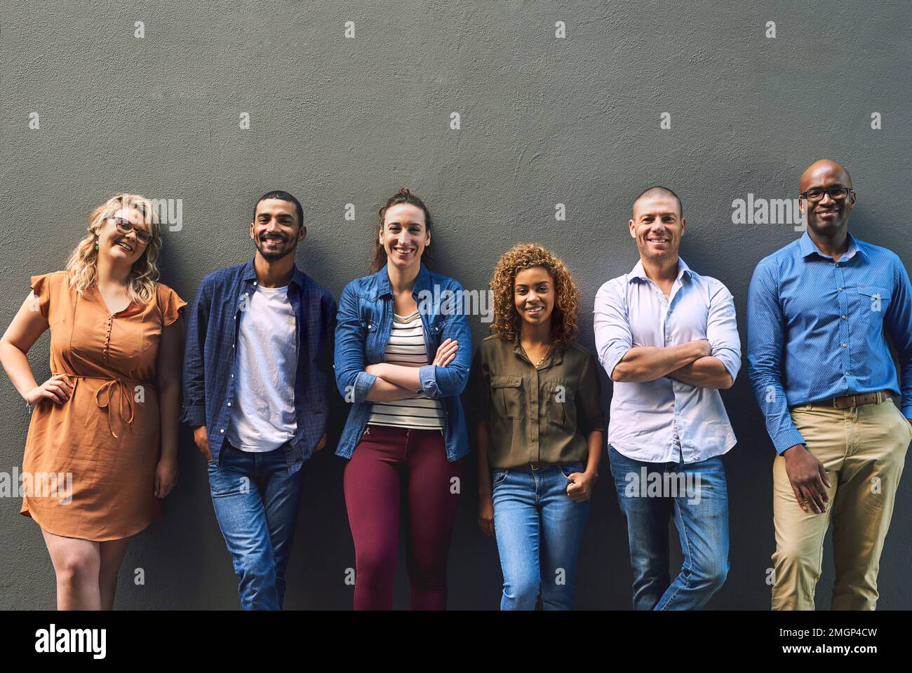 We make a great team. a group cheerful friends standing together for a ...