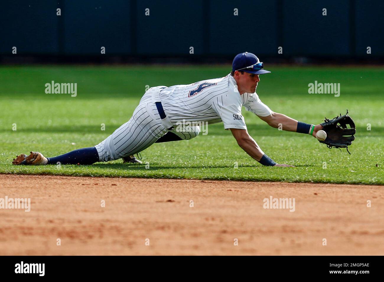Samford infielder Brooks Carlson (14) tries to field a ground ball ...