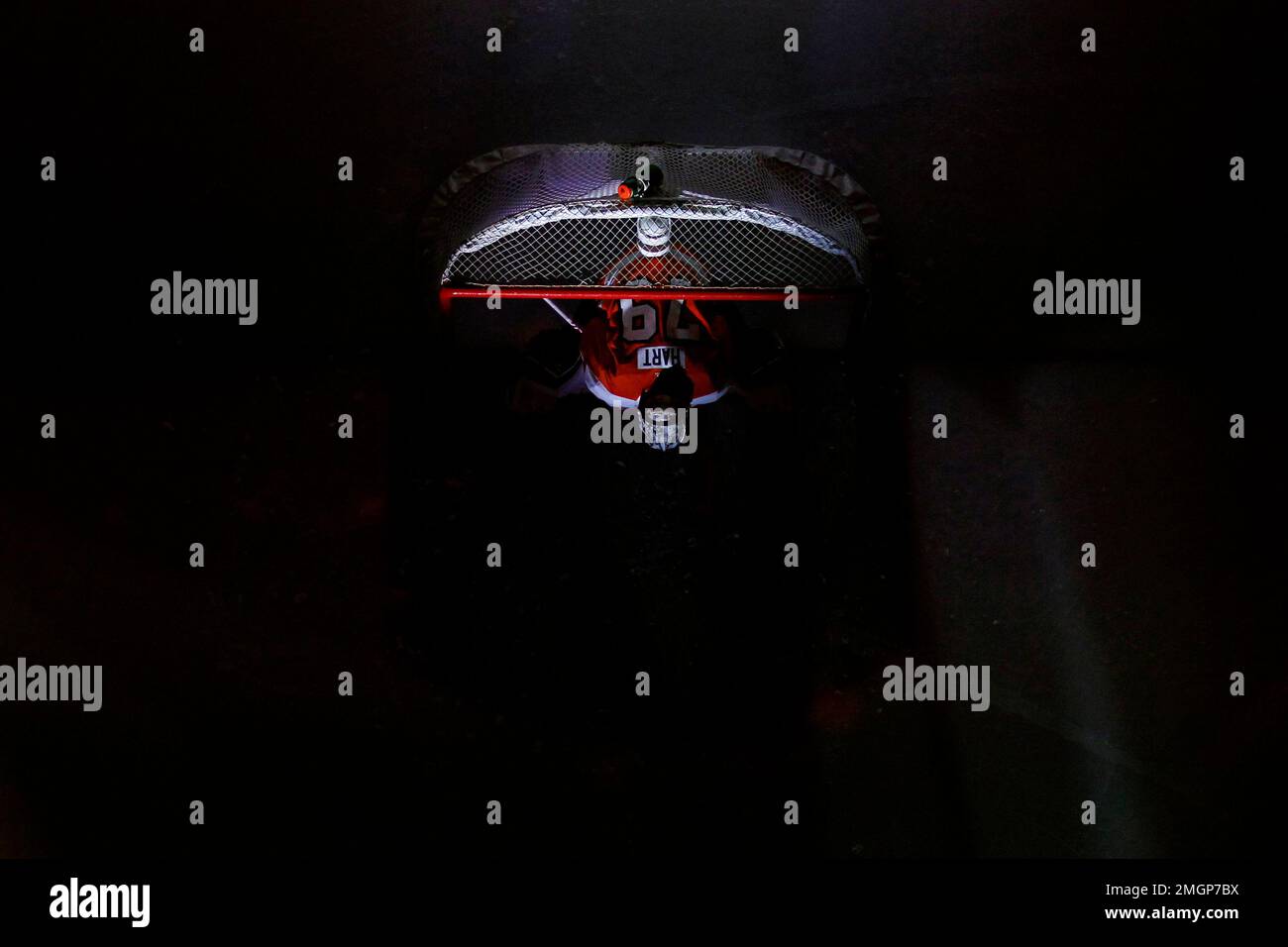 Philadelphia Flyers' Carter Hart sits in goal before an NHL hockey game ...