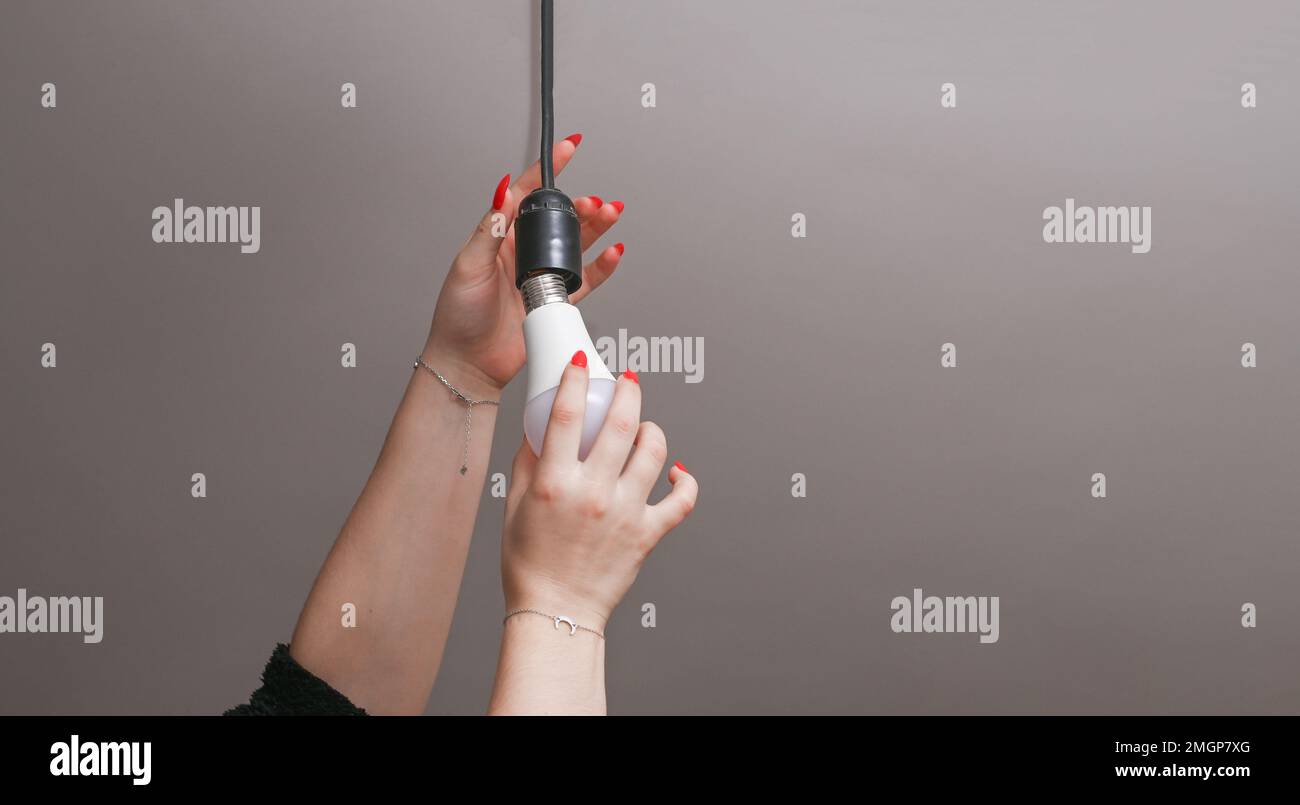 LED lamp in beautiful female hands. replacement of the electric lamp ...