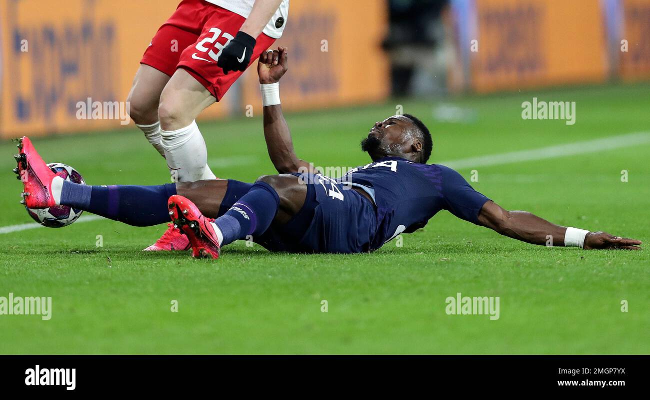 Tottenham's Serge Aurier is on the ground during the Champions League ...