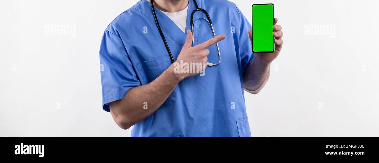 Doctor nurse in uniform and with a stethoscope points to a smartphone ...