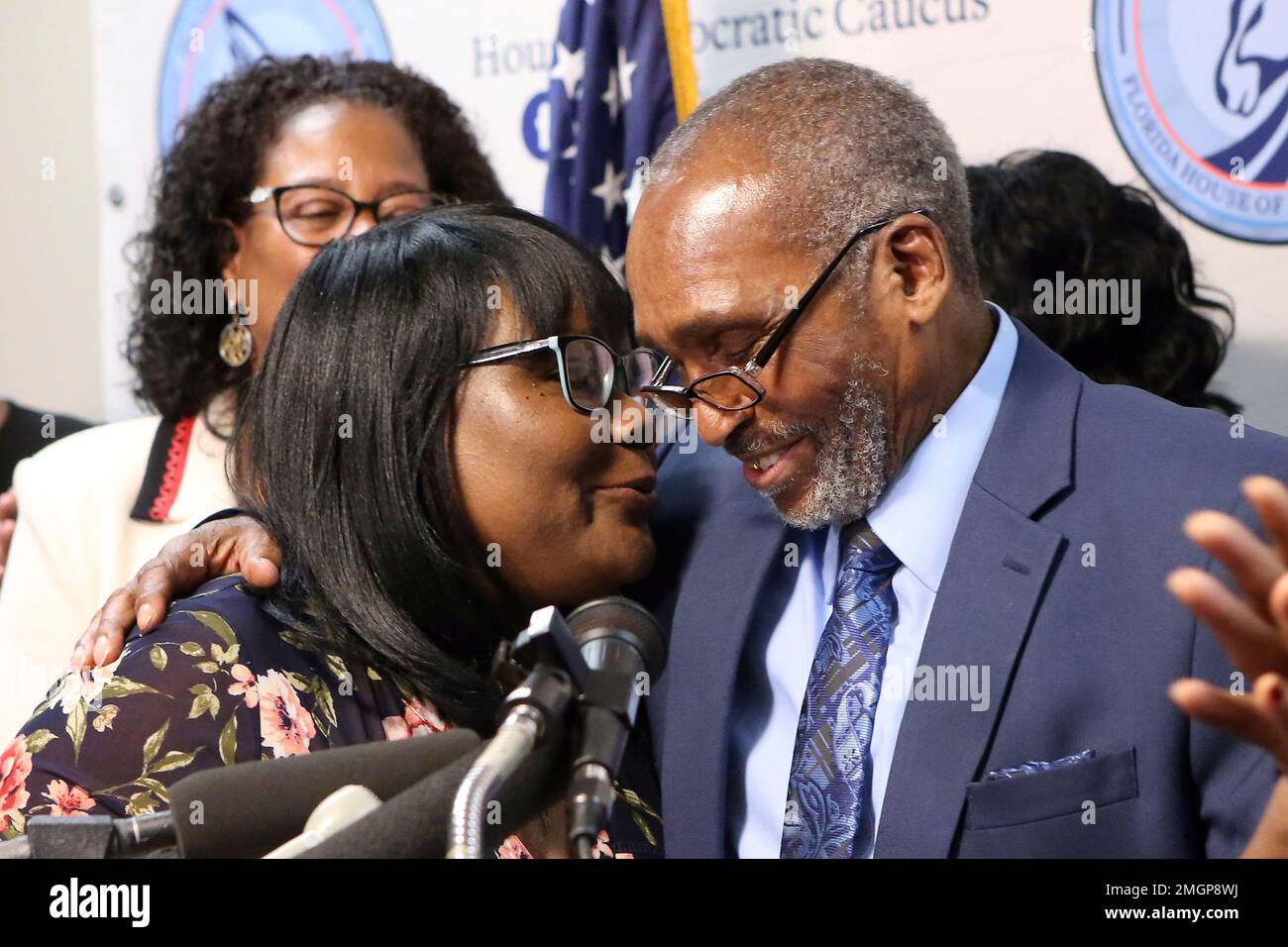 Clifford Williams, right, gets a hug from his daughter during a news ...