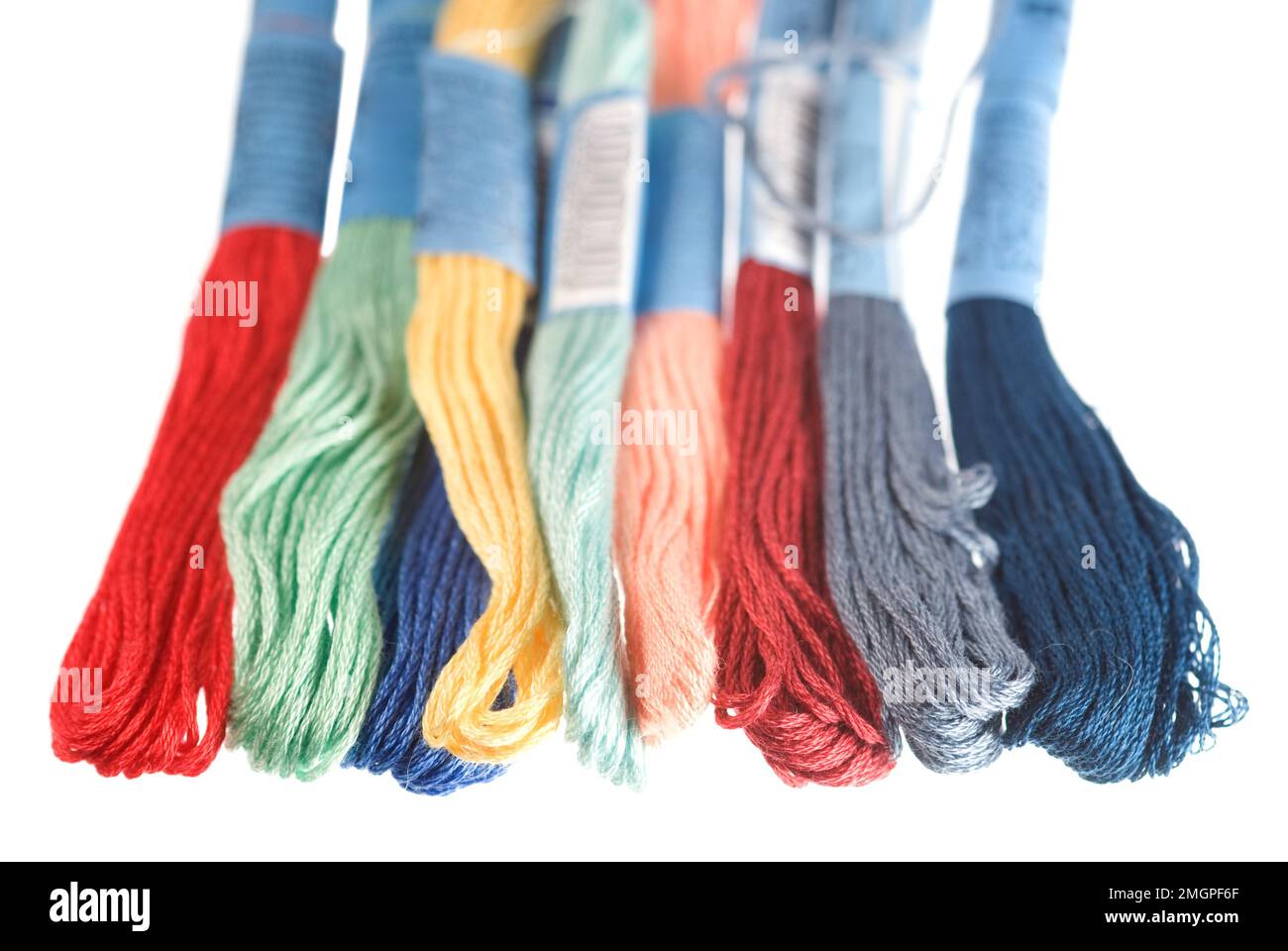 Different color embroidery threads isolated on white Stock Photo - Alamy