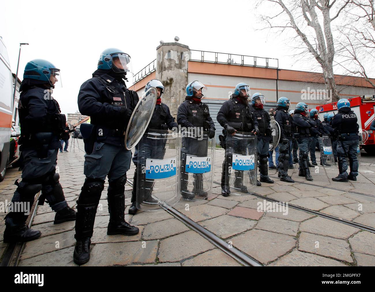 Police officers stand outside the San Vittore prison after inmates ...