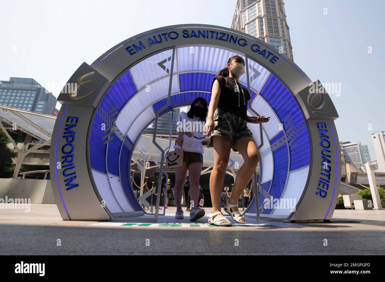 Peoples walk through a 'Auto Sanitizing Gate' in hopes to avoid the ...