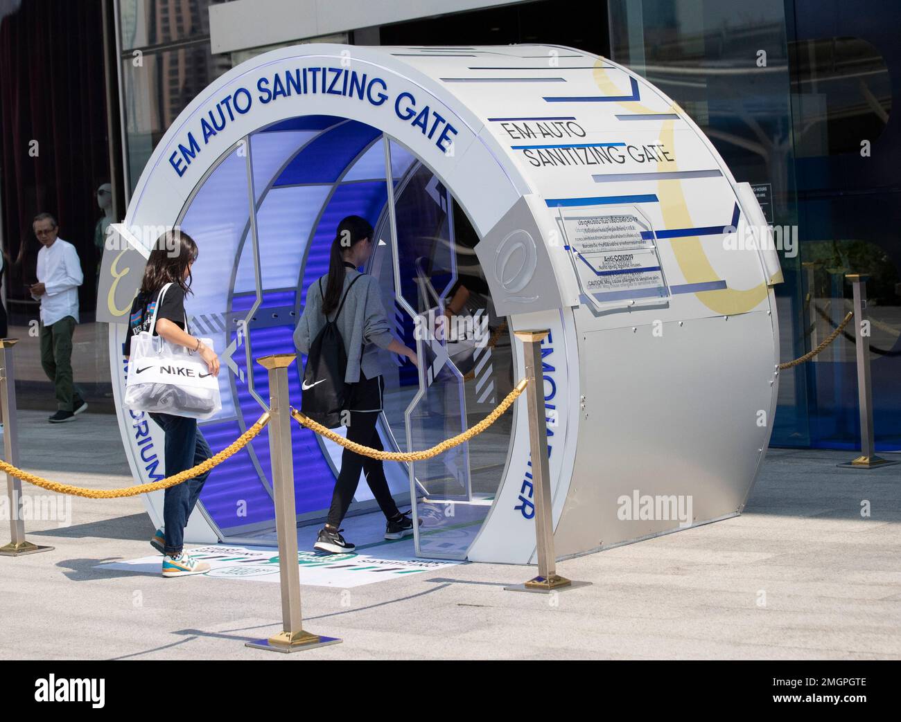 People walk though a 'Auto Sanitizing Gate' in hopes to avoid the ...