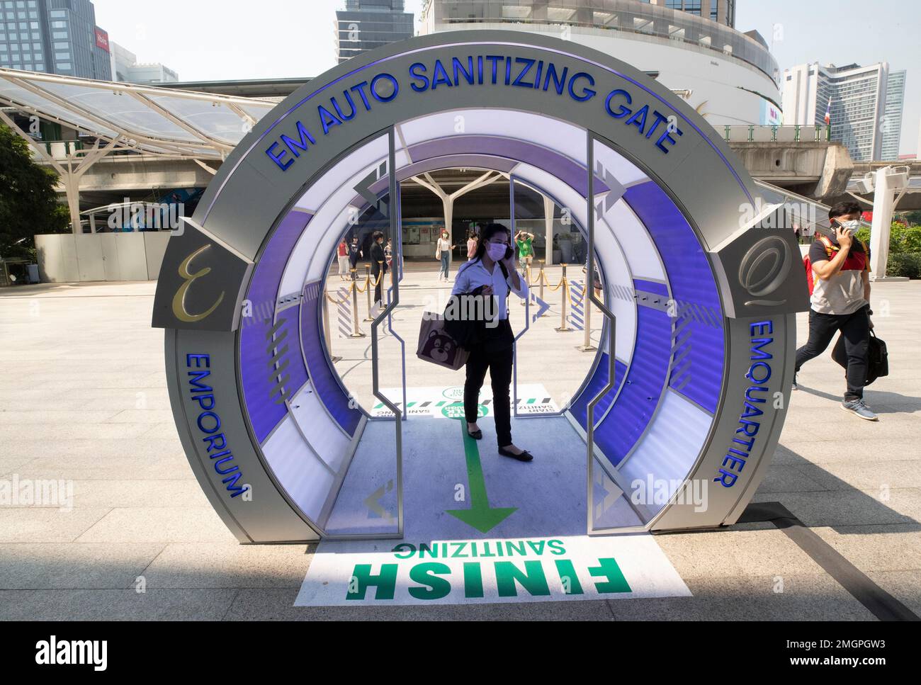 Peoples walk through a 'Auto Sanitizing Gate' in hopes to avoid the ...