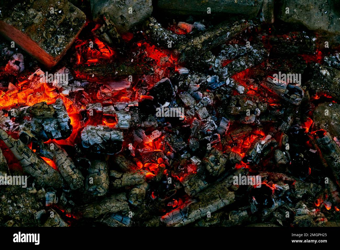 Campfire with fading flame and smoldering coals. Time for cooking meat ...