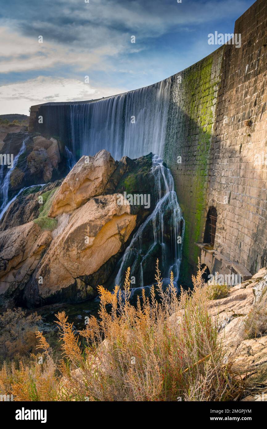 A vertical view of the waterfall and overflow of the dam wall of the Elche Reservoir Stock Photo ...