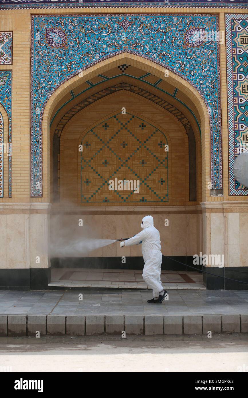 Iraqi health officials spray disinfectant as a precaution against the ...