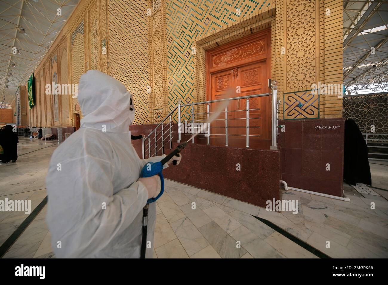 Iraqi health officials spray disinfectant as a precaution against the ...