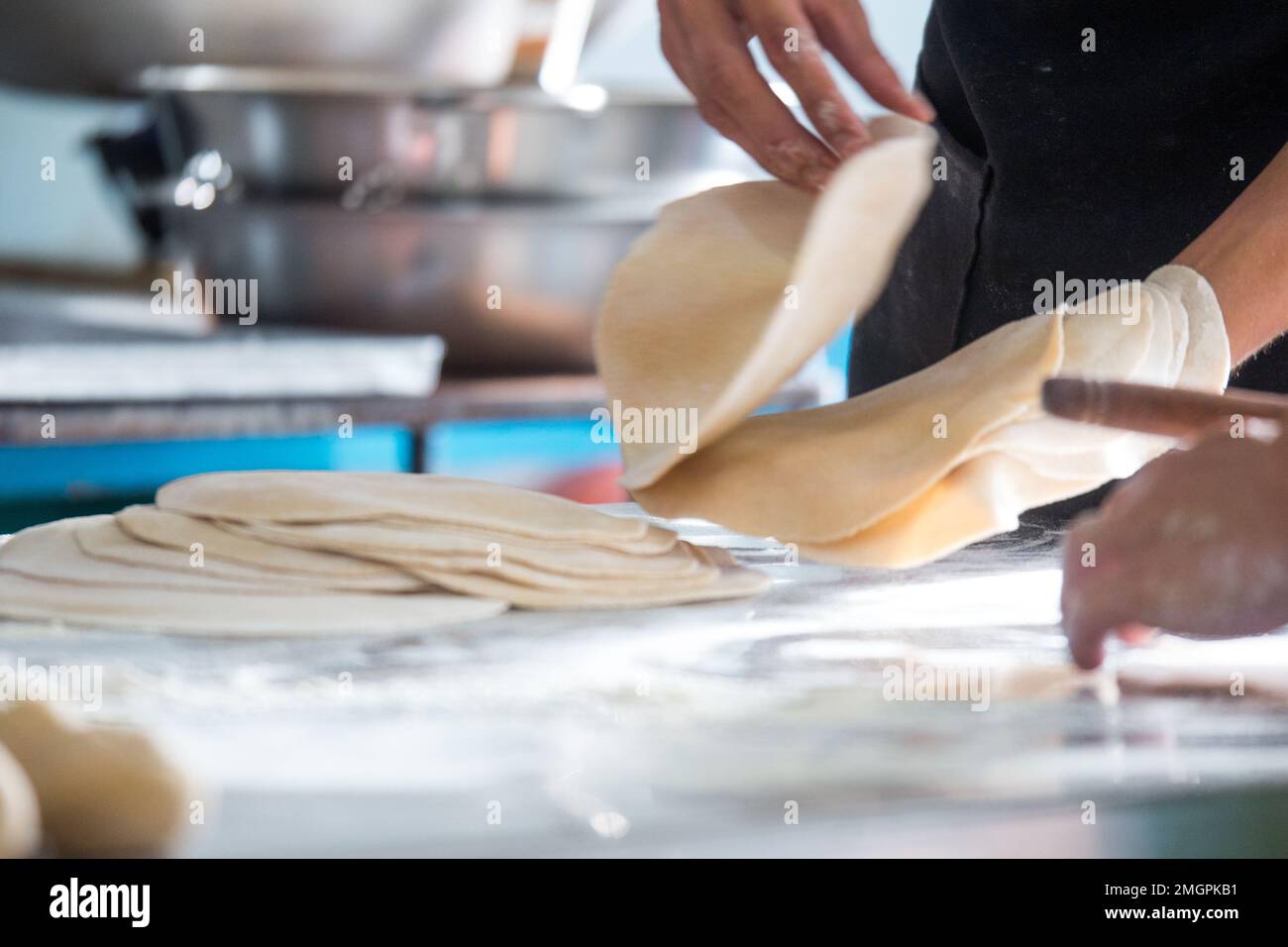 A closeup shot of a chef kneading dough in order to make Chapatti bread ...