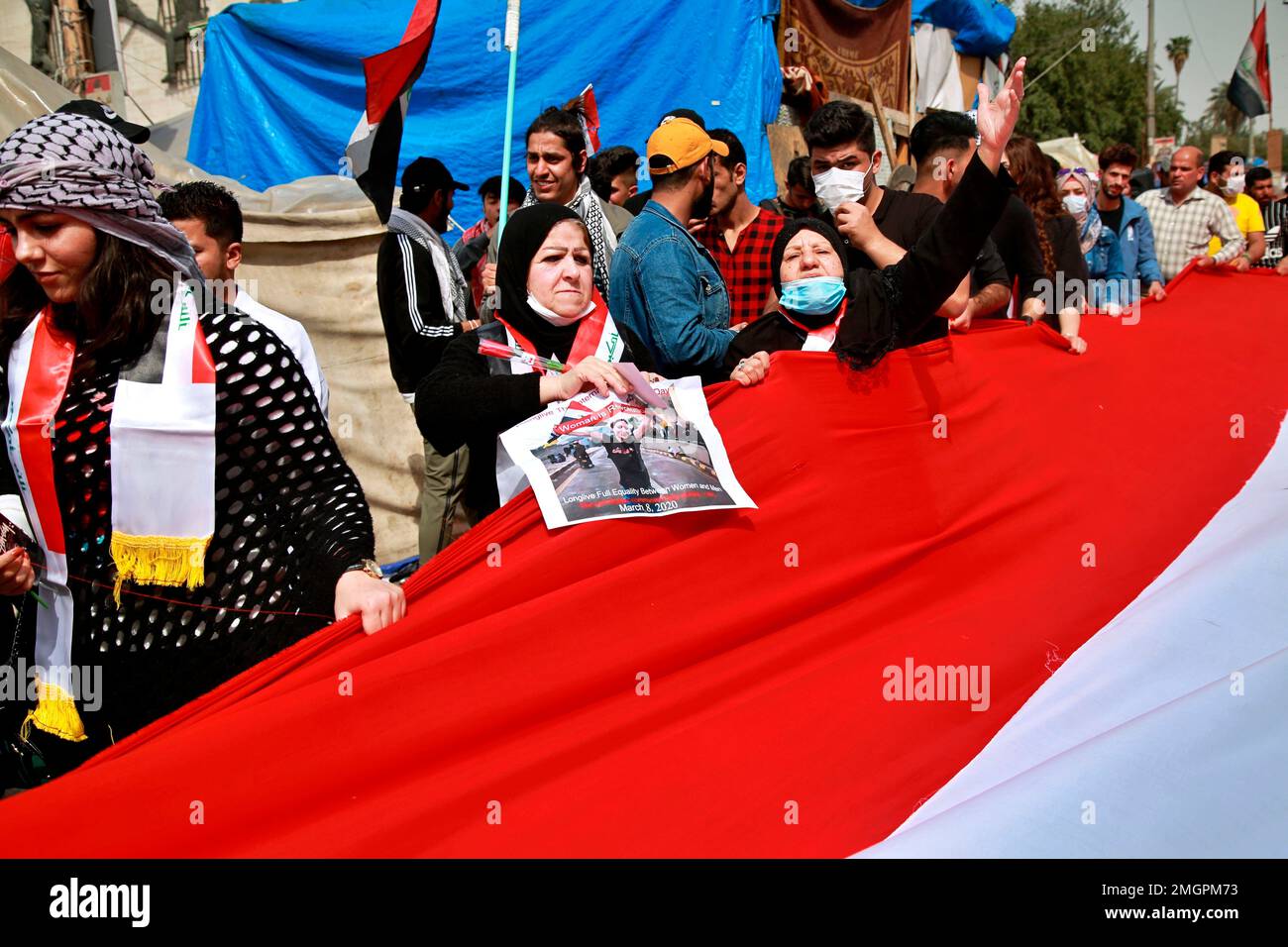 Anti-government protesters hold Iraqi flags during a rally demanding ...