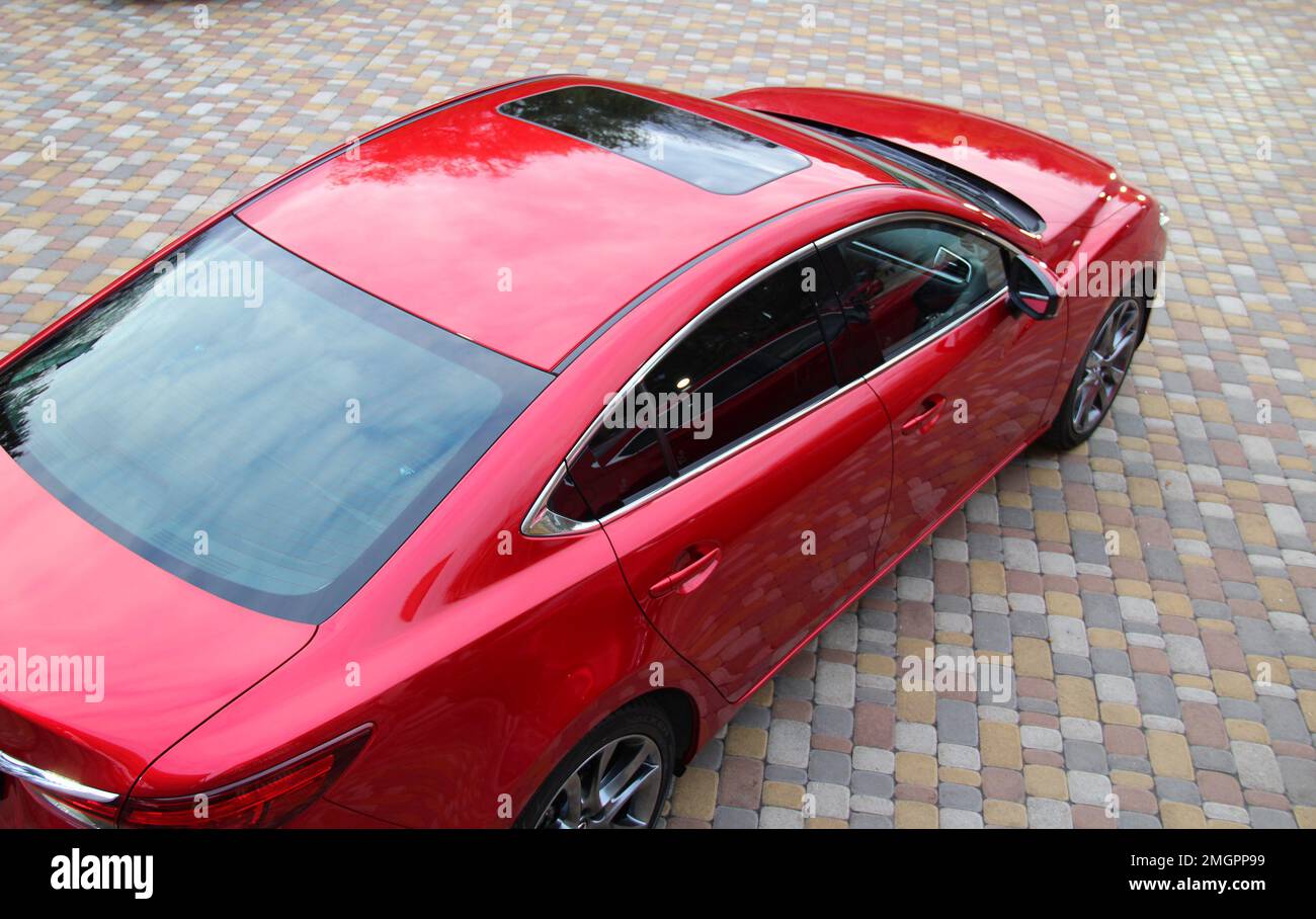 Red Car Parked On A Colored Paving Slabs Top View Stock Photo - Alamy
