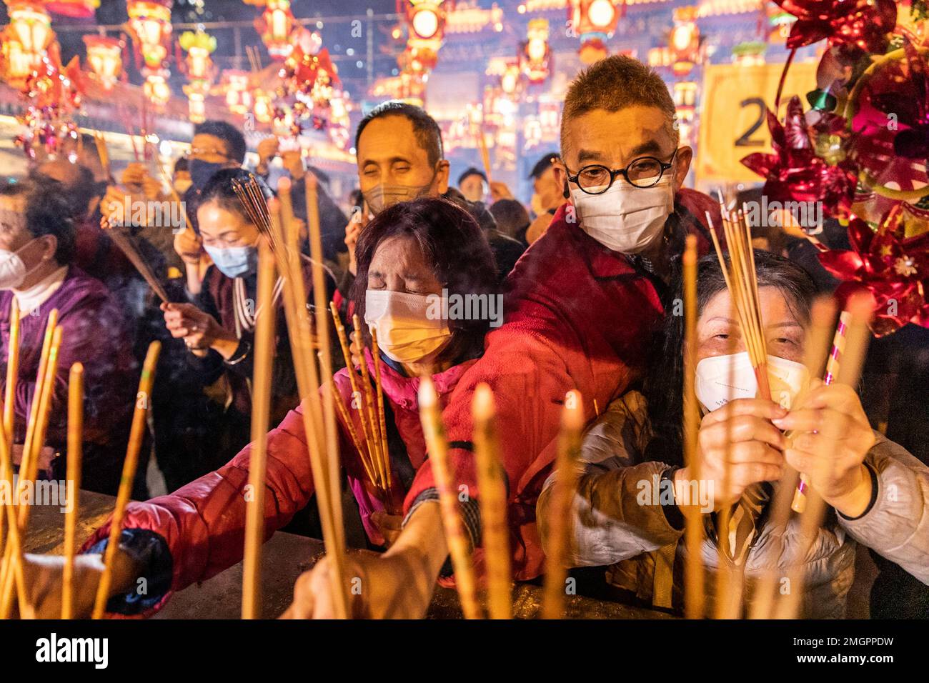 Worshippers burn their first joss sticks at the incense burner, at the ...