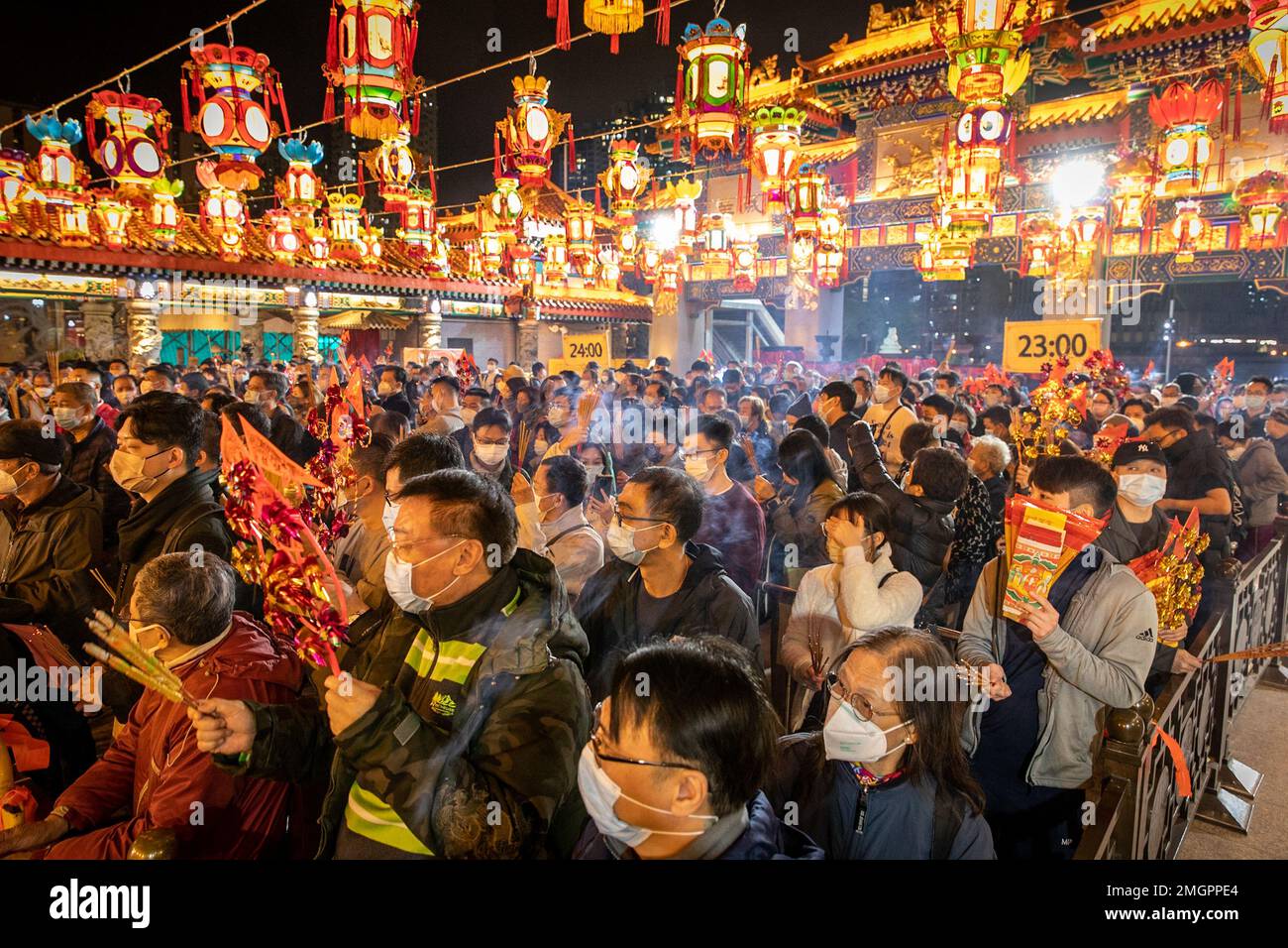 Worshippers queue up to burn their first joss sticks at the Wong Tai ...