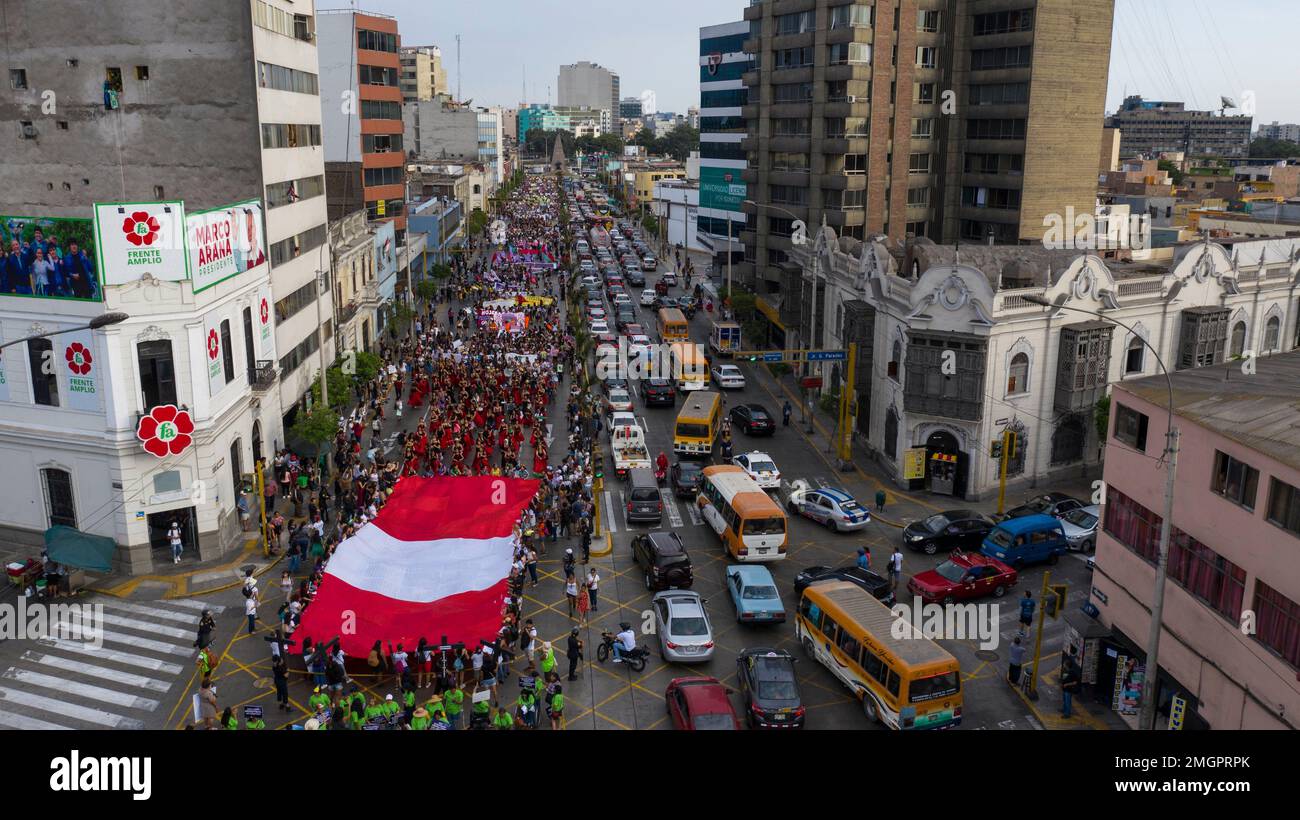 Women march with a giant Peruvian national flag in a protest march to ...