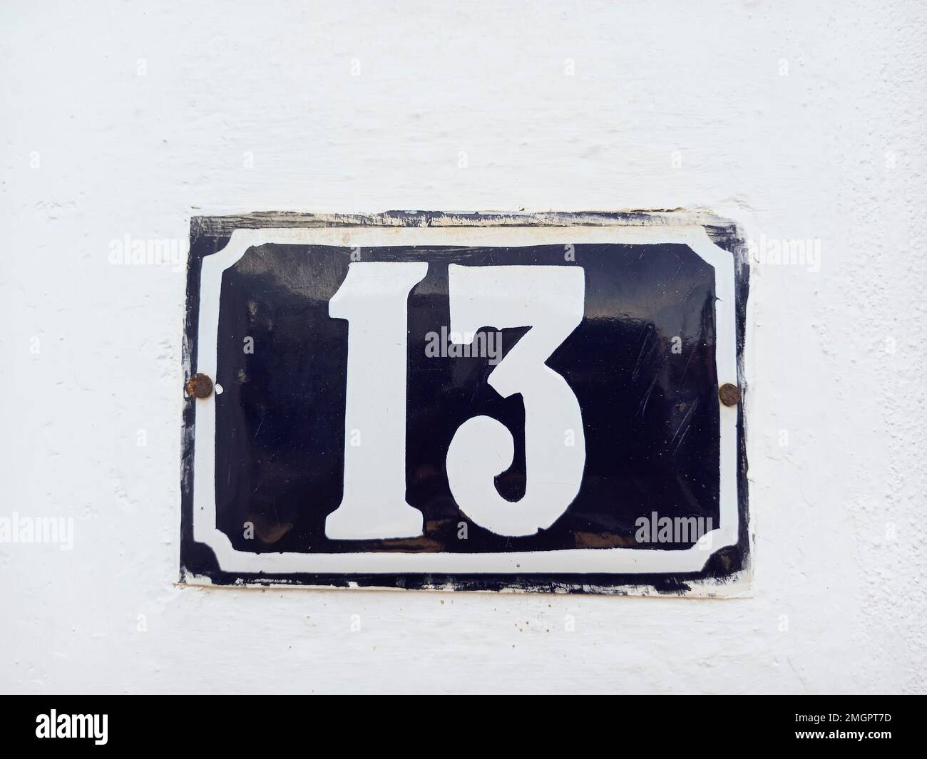 number thirteen in metallic plate format, with copy space and blue and ...