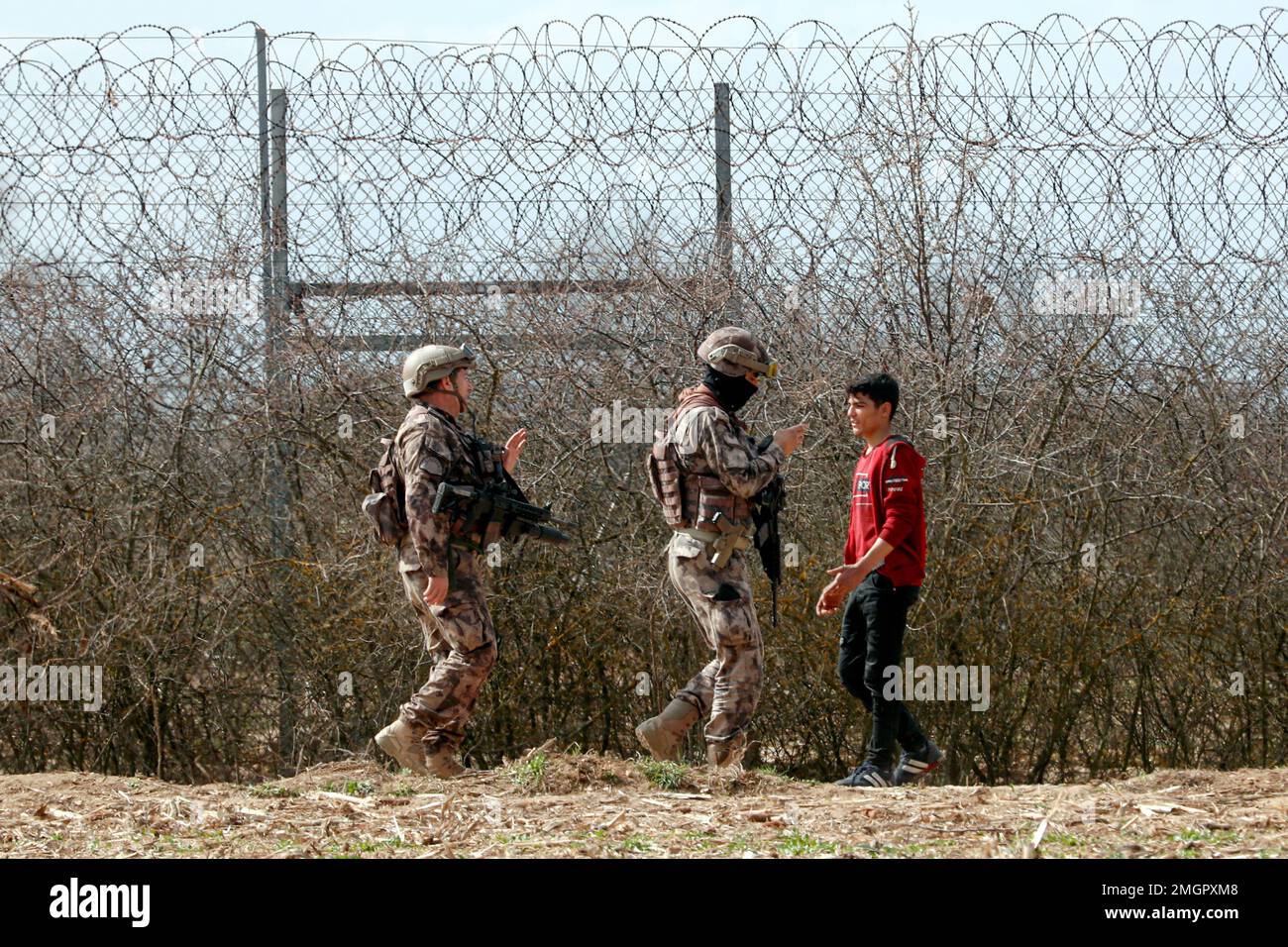 Turkish special police officers patrol by the fence on the Turkish ...