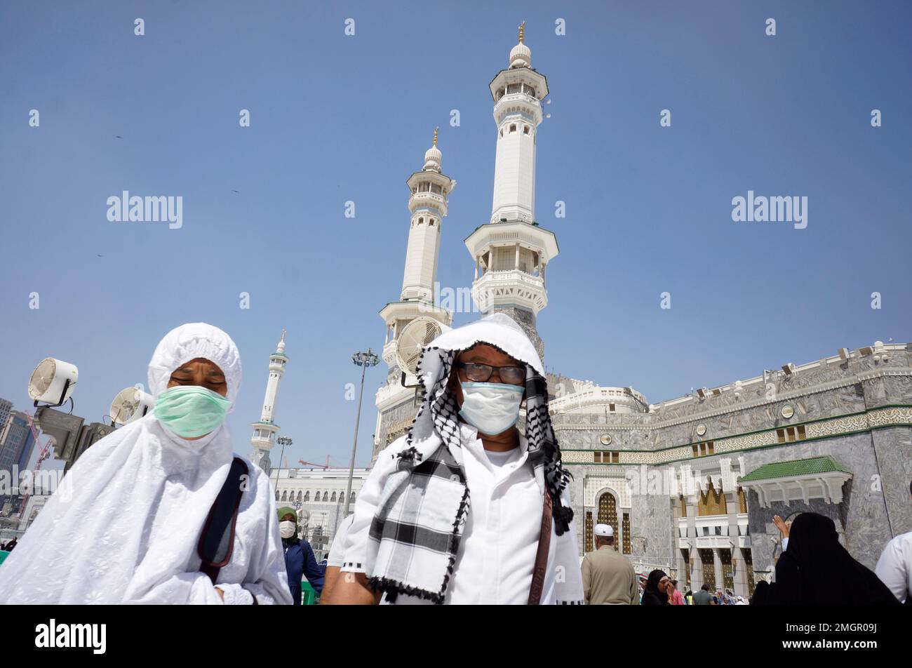 Muslim worshippers wear masks after the noon prayers outside the Grand ...