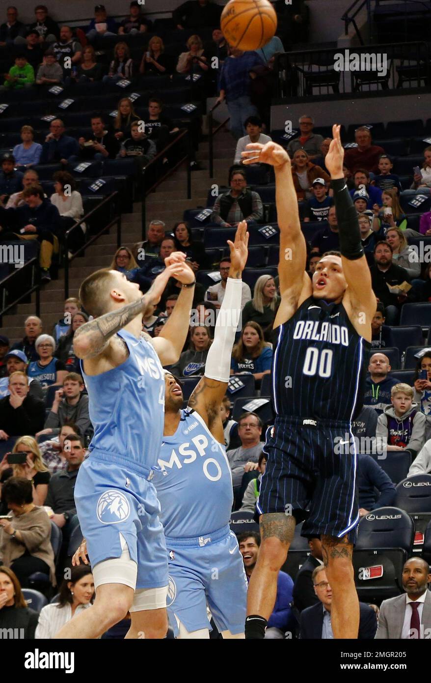 Orlando Magic's Aaron Gordon, right, shoots past Minnesota Timberwolves ...
