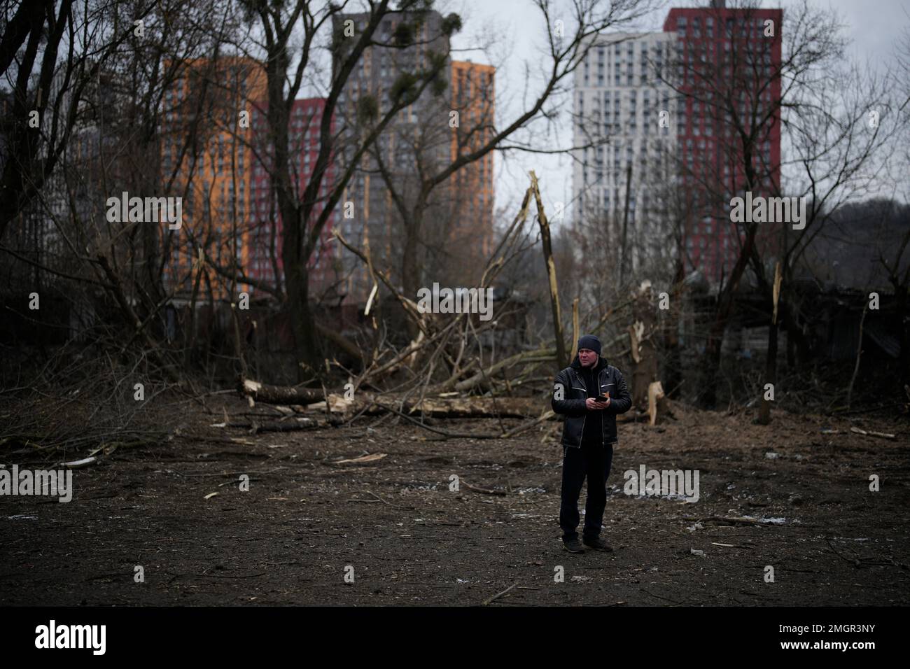 A man stands at a site of a rocket attack in Kyiv, Ukraine, Thursday ...