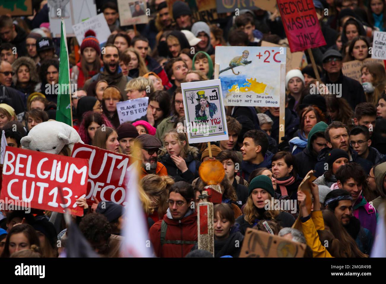 People shout slogans as they march during a climate change protest in ...