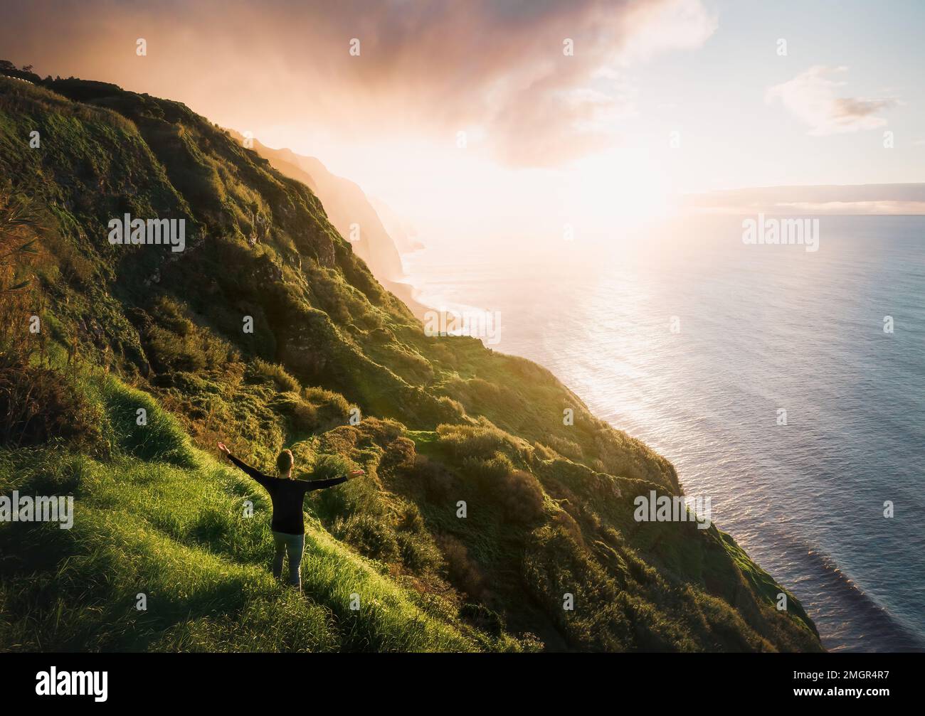 Beautiful Sunset on the Island of Madeira with a Man Spreading his Arms ...