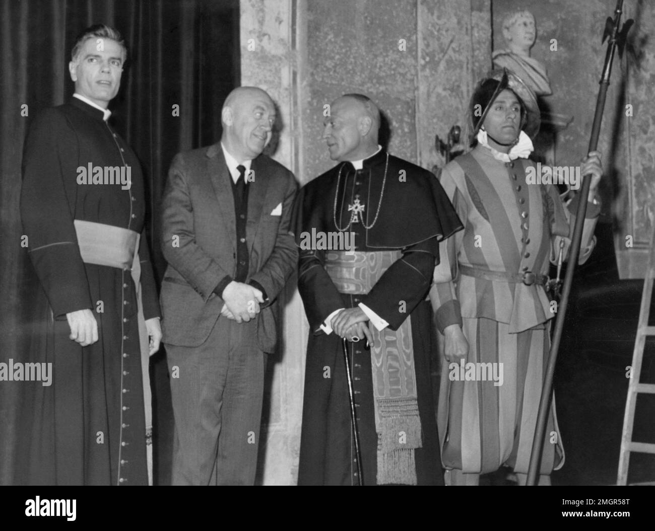 Left to right; American actor Tom Tryon, wearing the robe of a priest ...