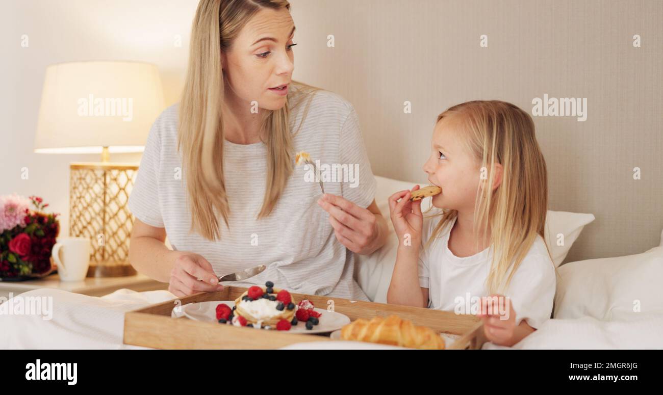 Mother, child and breakfast in the bed of their house together in the ...