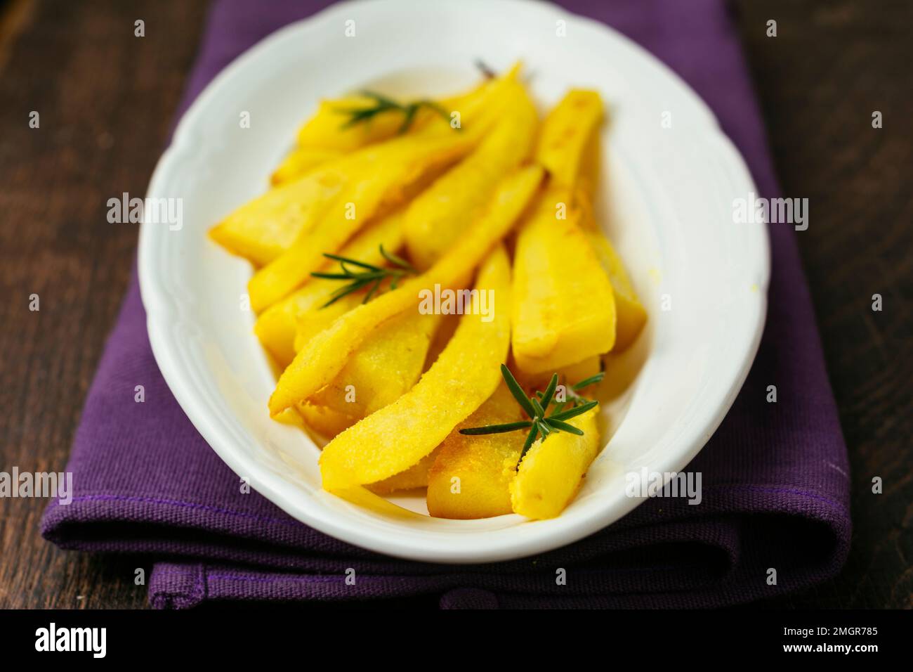 Side dish with turmeric roasted parsnip slices Stock Photo - Alamy