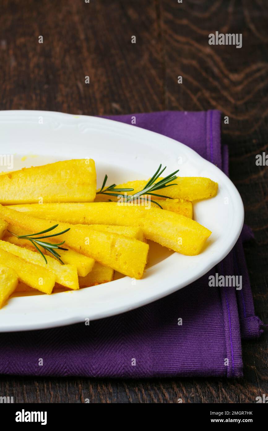 Side dish with turmeric roasted parsnip slices Stock Photo - Alamy