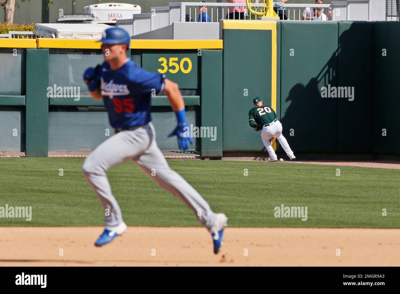 Los Angeles Dodgers' Cody Thomas, left, runs towards second base as ...