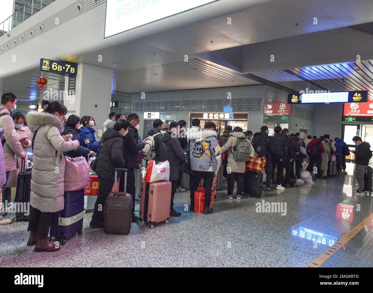 FUYANG, CHINA - JANUARY 26, 2023 - Passengers line up at Fuyang West ...