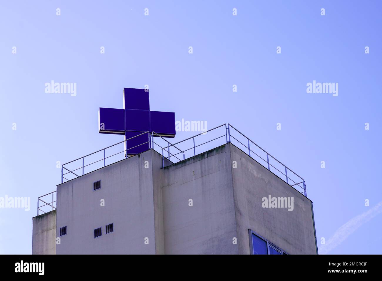 hospital building facade with big roof blue cross Stock Photo - Alamy