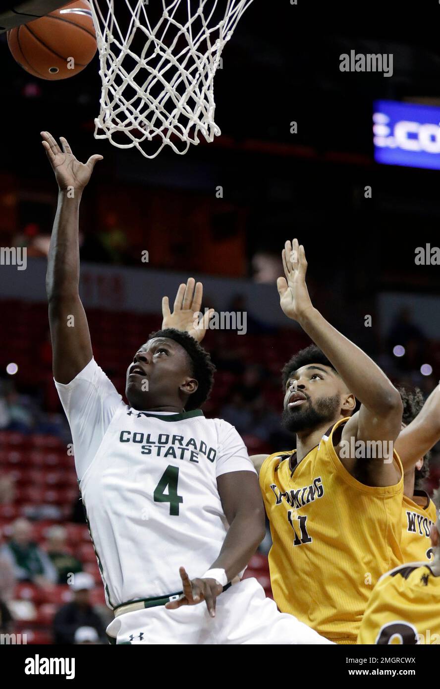 Colorado State's Isaiah Stevens (4) shoots as Wyoming's Trevon Taylor ...