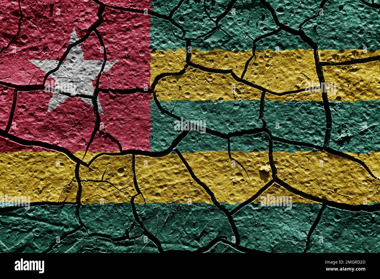 Togo flag on a mud texture of dry crack on the ground Stock Photo - Alamy