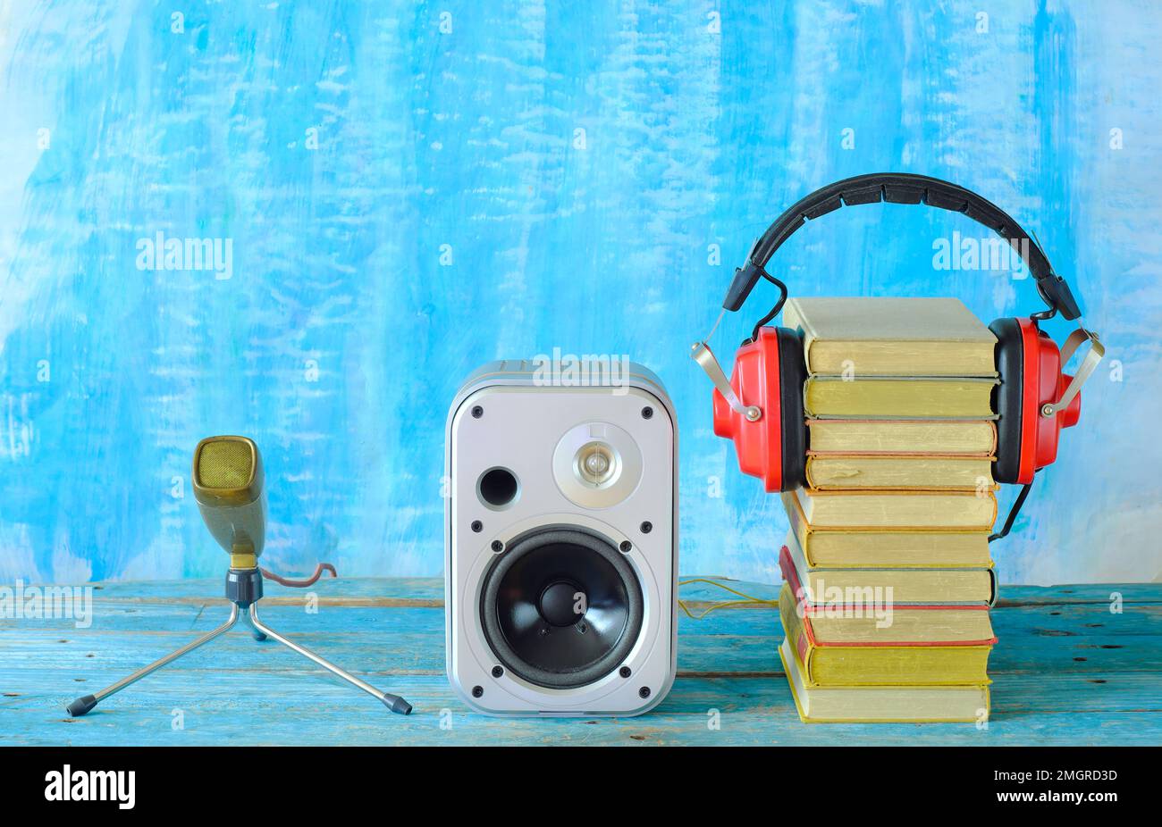 audio book concept with stack of books and vintage headphones ...