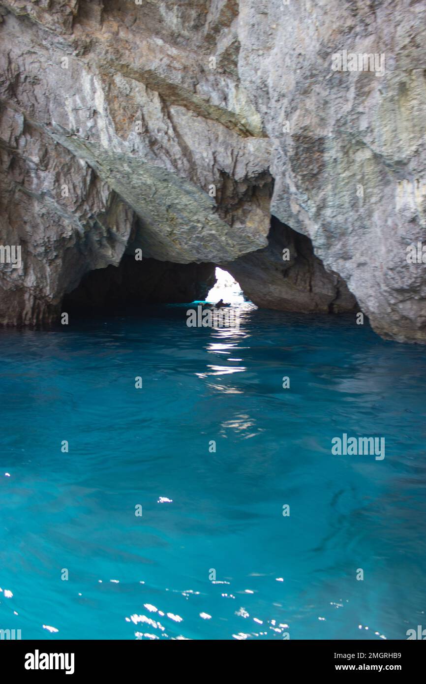 A vertical shot of a cave with blue water on Capri Island, Naples ...